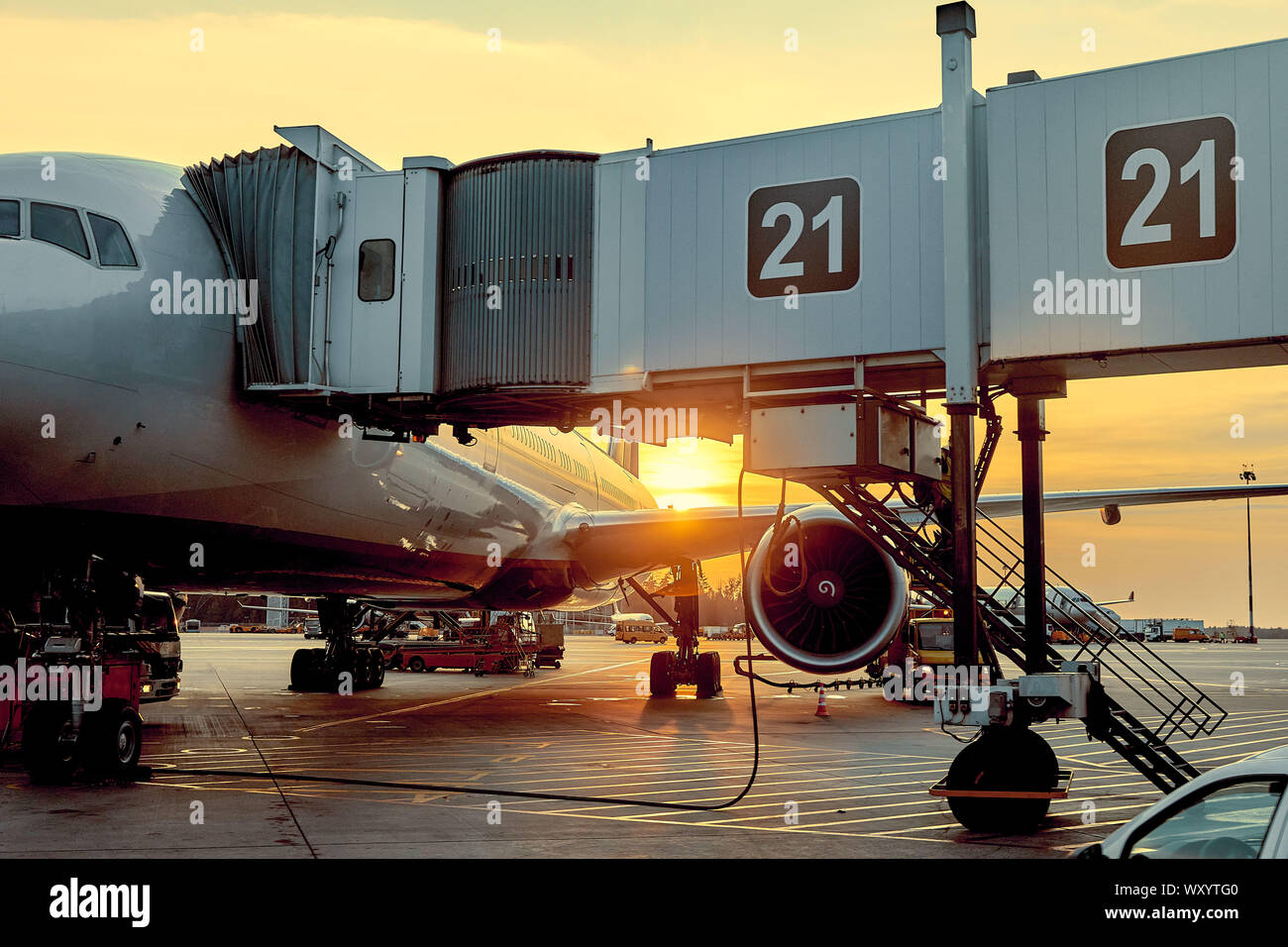 Modern passenger airplane parked to terminal building gate at airside ...
