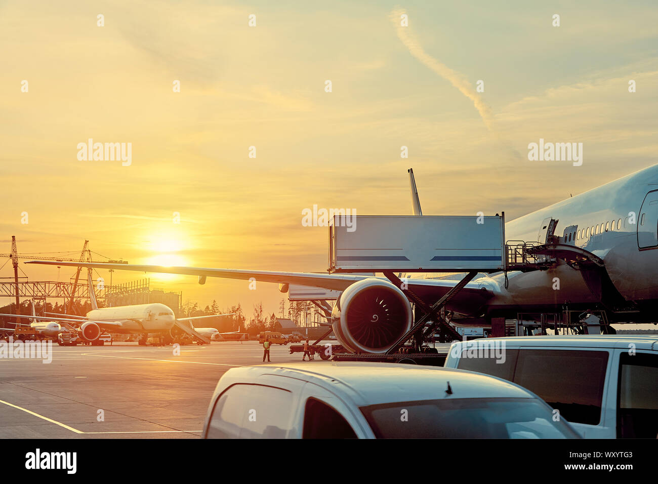 Modern passenger airplane parked to terminal building gate at airside ...