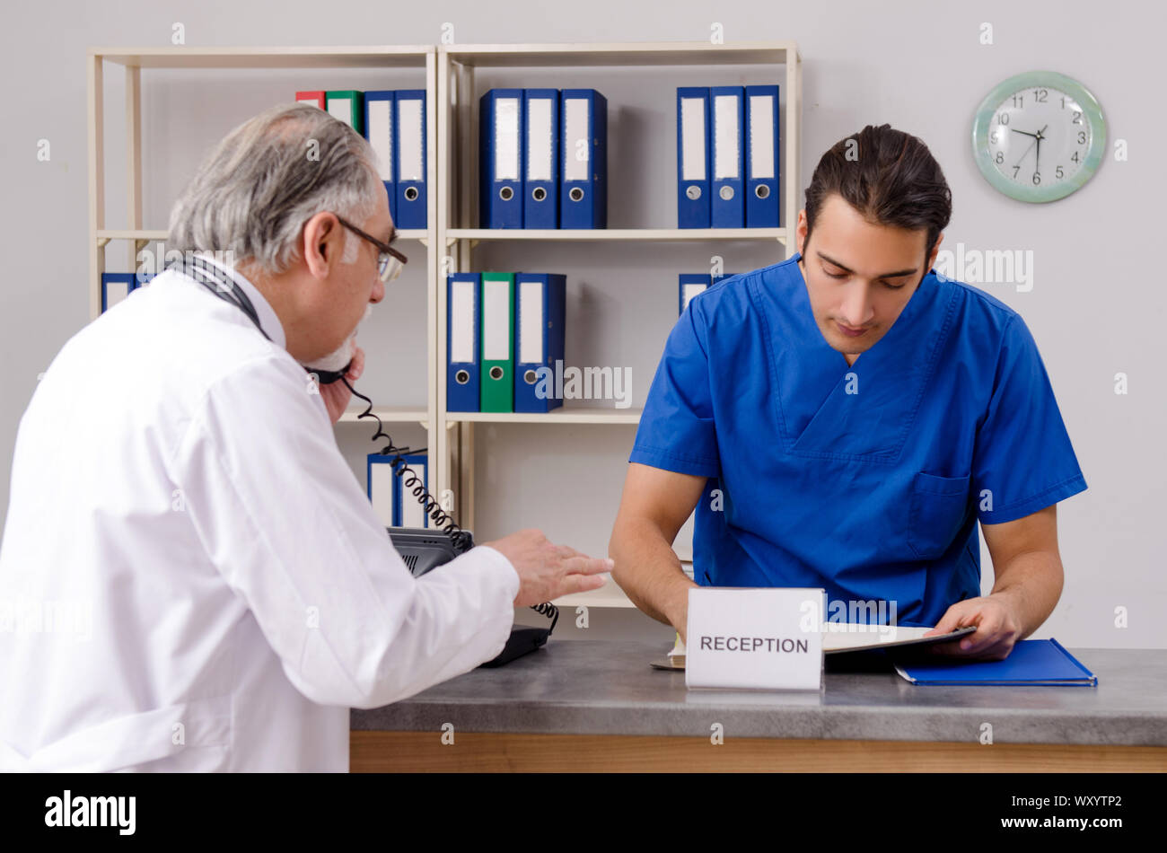 Doctors talking at the reception in hospital Stock Photo - Alamy