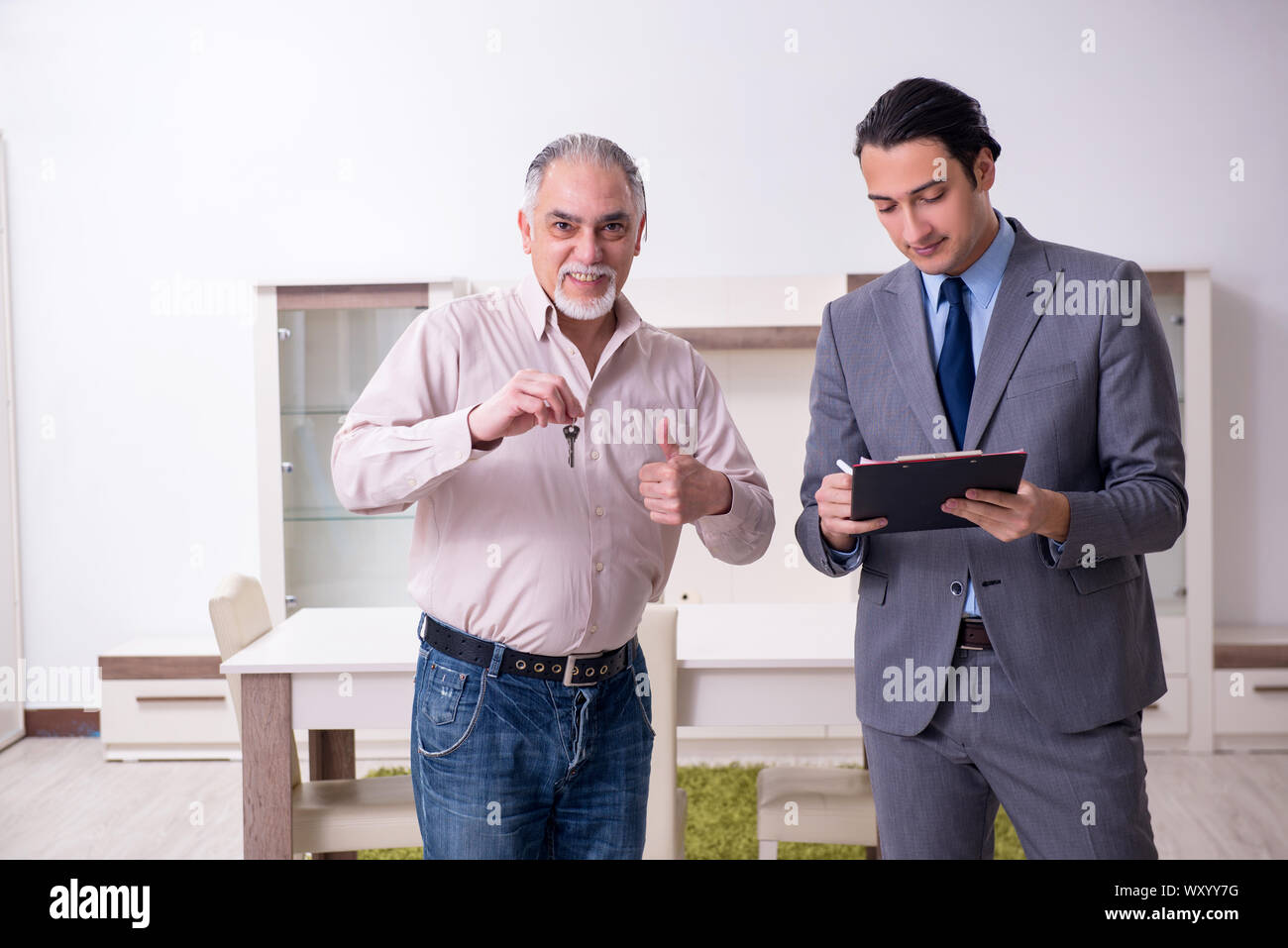 The male real estate agent and male client in the apartment Stock Photo ...