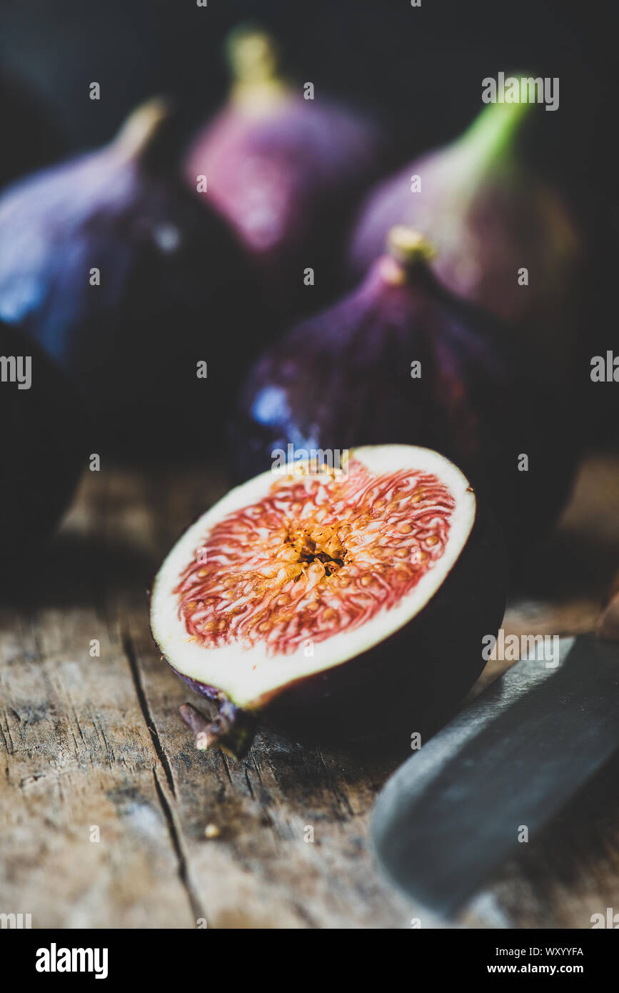 Fresh ripe seasonal purple figs over wooden board Stock Photo - Alamy