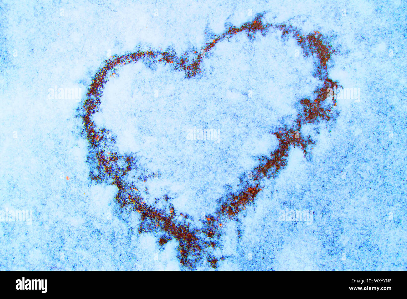 Sign of love-heart painted on snow, pastel blue background, Valentine's ...