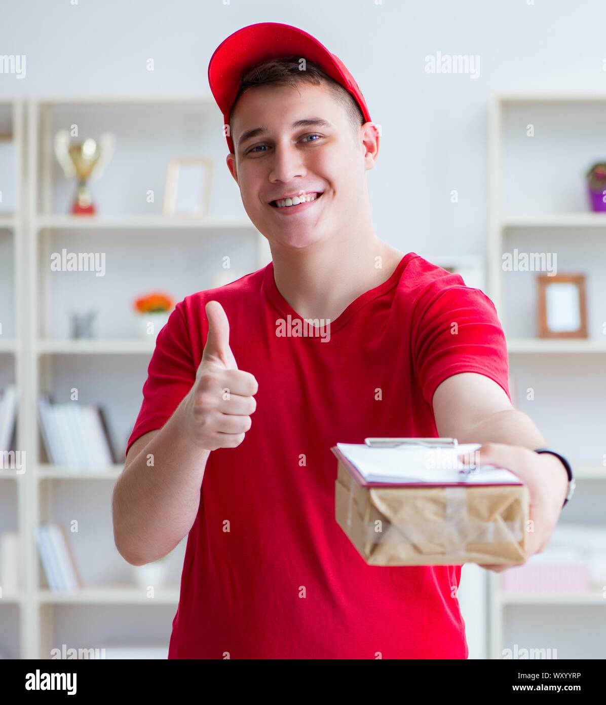 The post man delivering a parcel package Stock Photo - Alamy