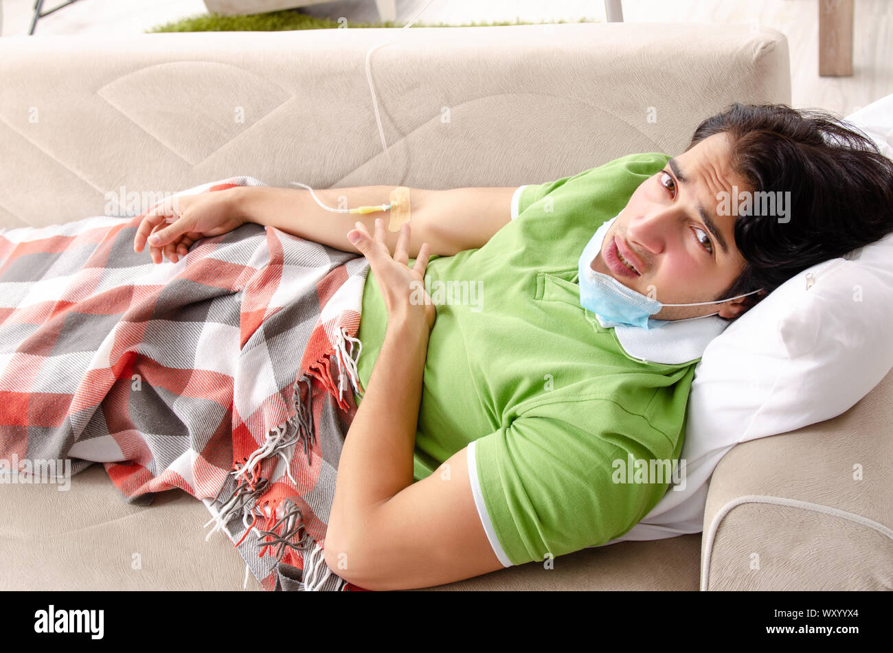 The young man suffering at home Stock Photo - Alamy