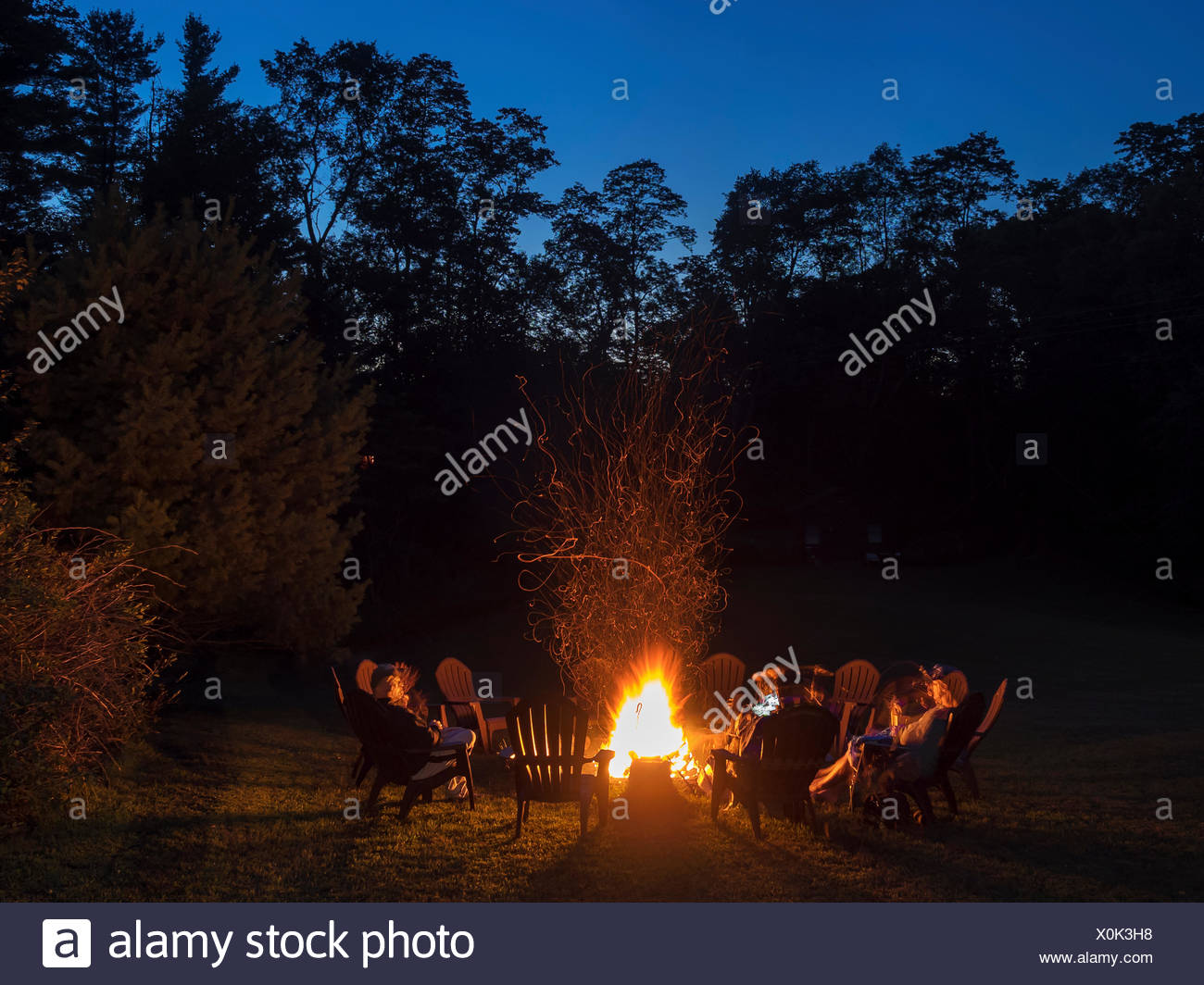 People Sitting Around Camp Fire High Resolution Stock Photography and ...