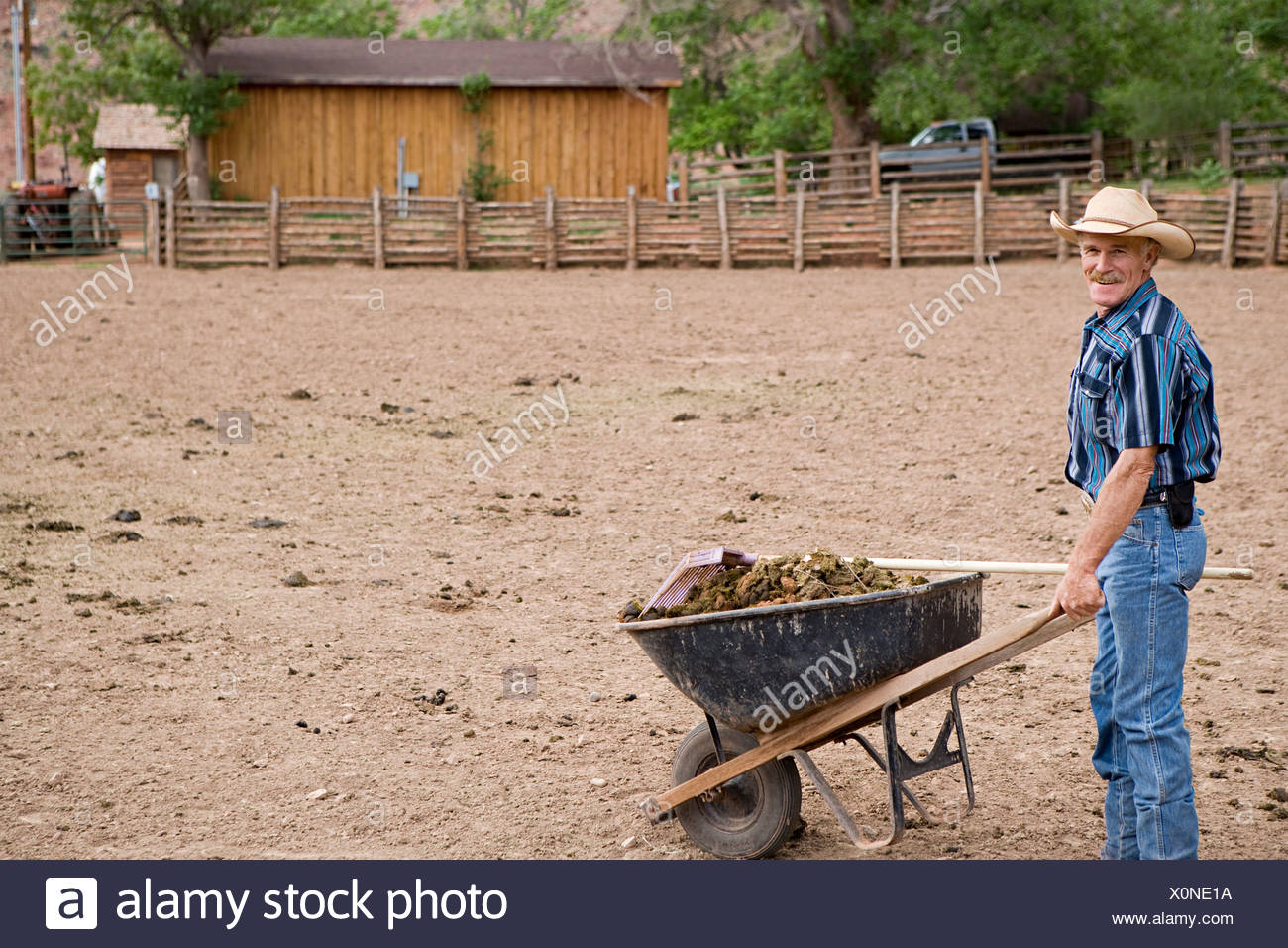 Man With Wheelbarrow Stock Photos & Man With Wheelbarrow Stock Images ...