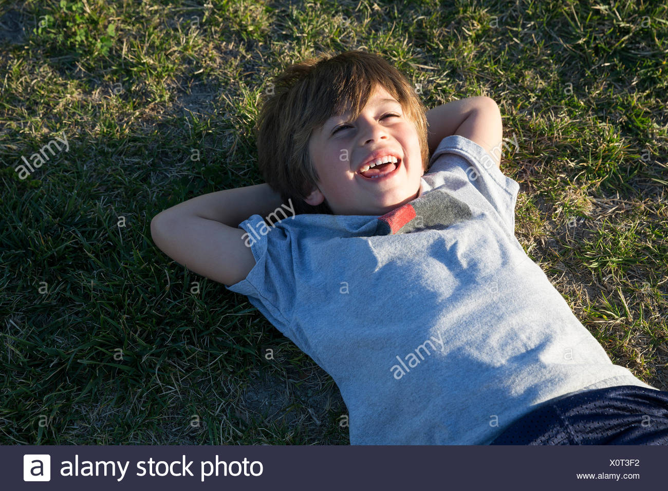 Boy Lying On Grass High Resolution Stock Photography and Images - Alamy