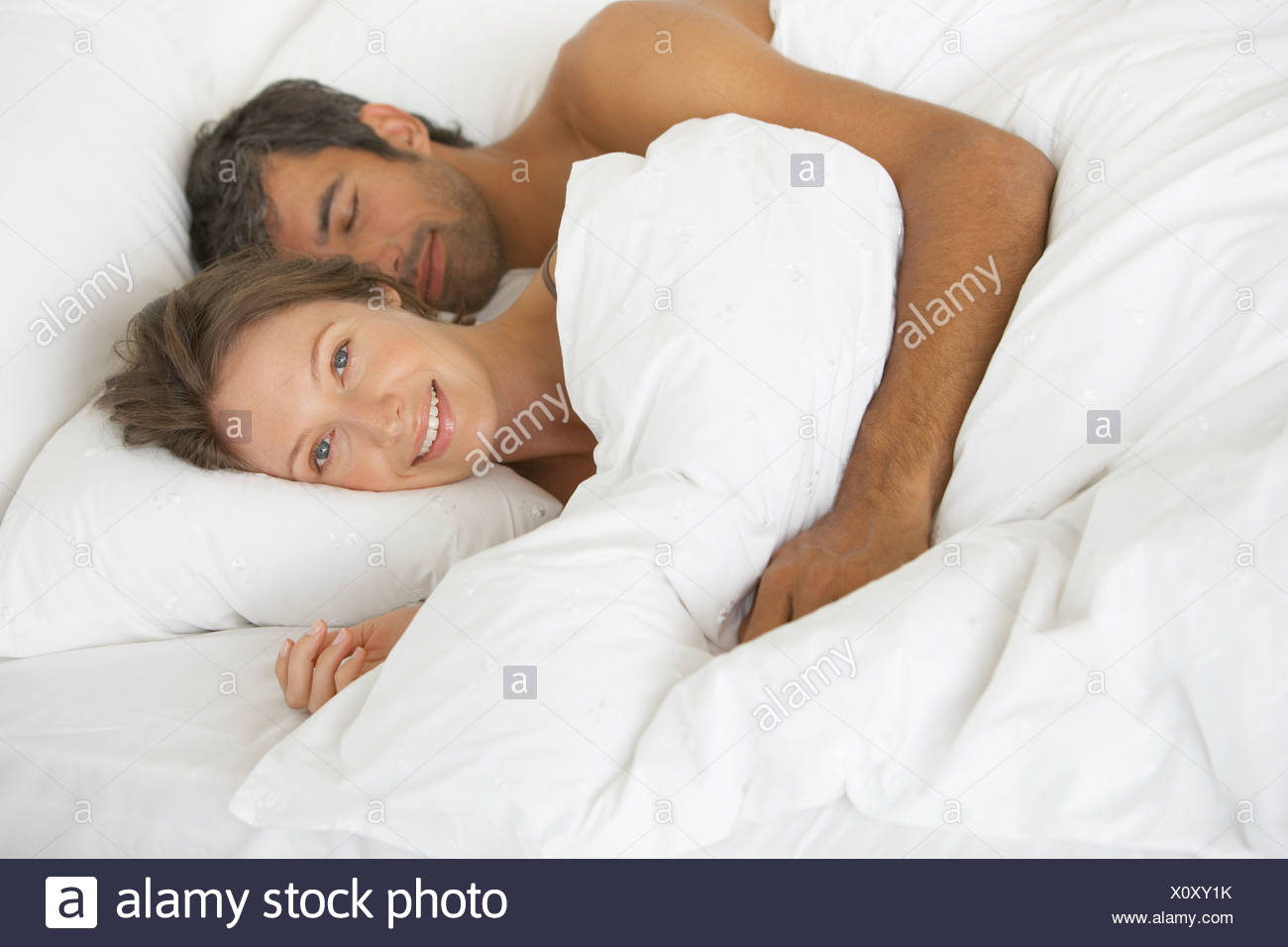 Man Woman Snuggling In Bed Stock Photos & Man Woman Snuggling In Bed ...