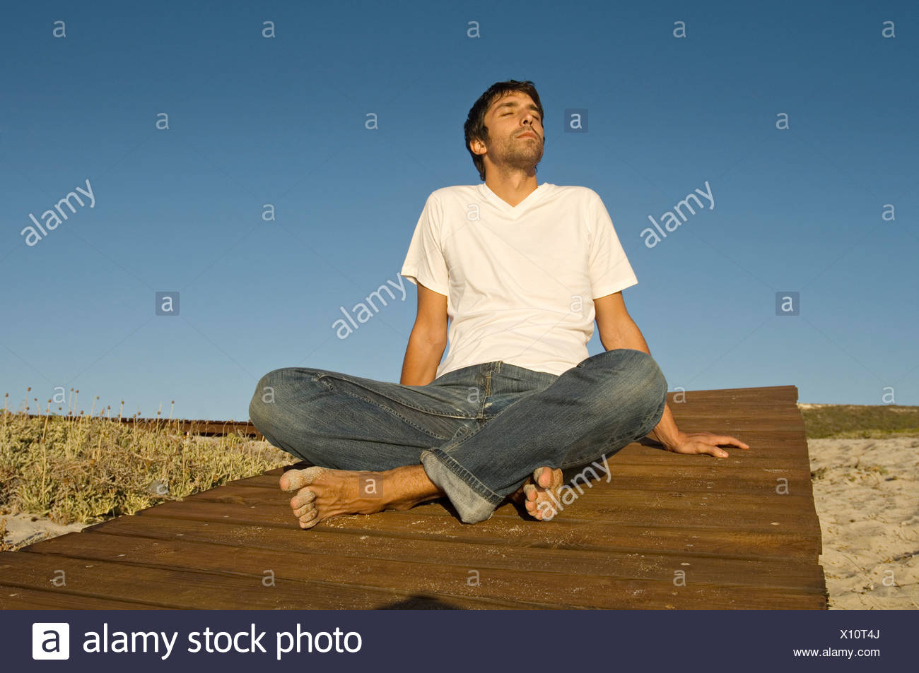 Young Man Sitting Cross Legged High Resolution Stock Photography and ...