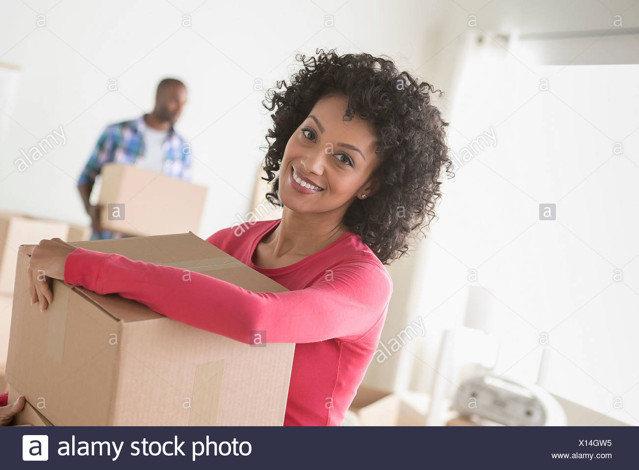 Woman Carrying Heavy Boxes High Resolution Stock Photography and Images ...