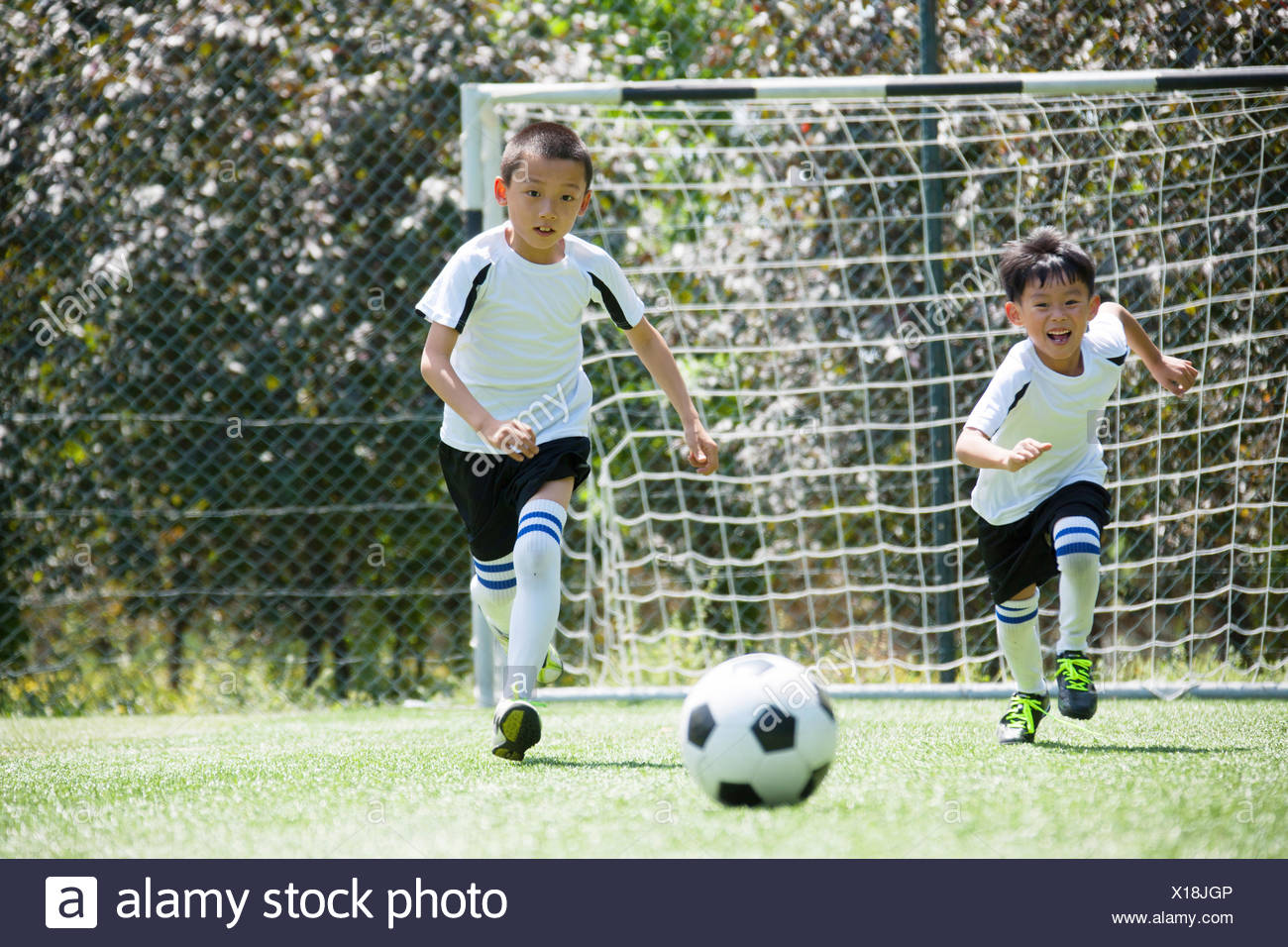 Two Boys Playing Football On Stock Photos & Two Boys Playing Football ...