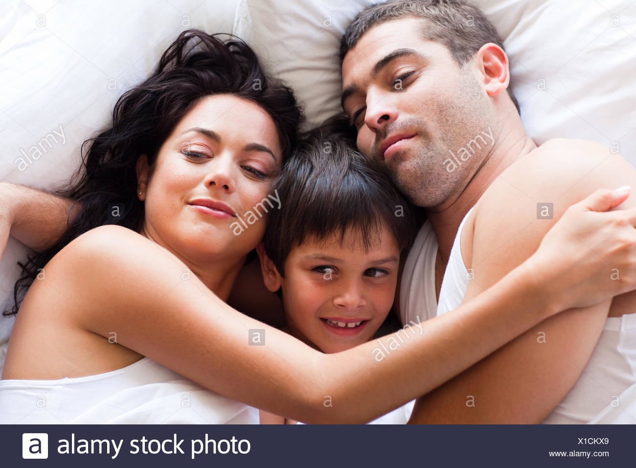 Family Of Three People Sleeping In One Bed Stock Photos & Family Of ...
