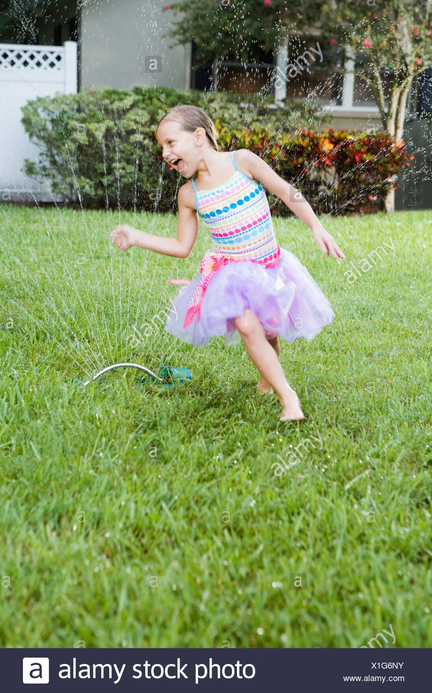 Girl Running Through Sprinkler High Resolution Stock Photography and ...