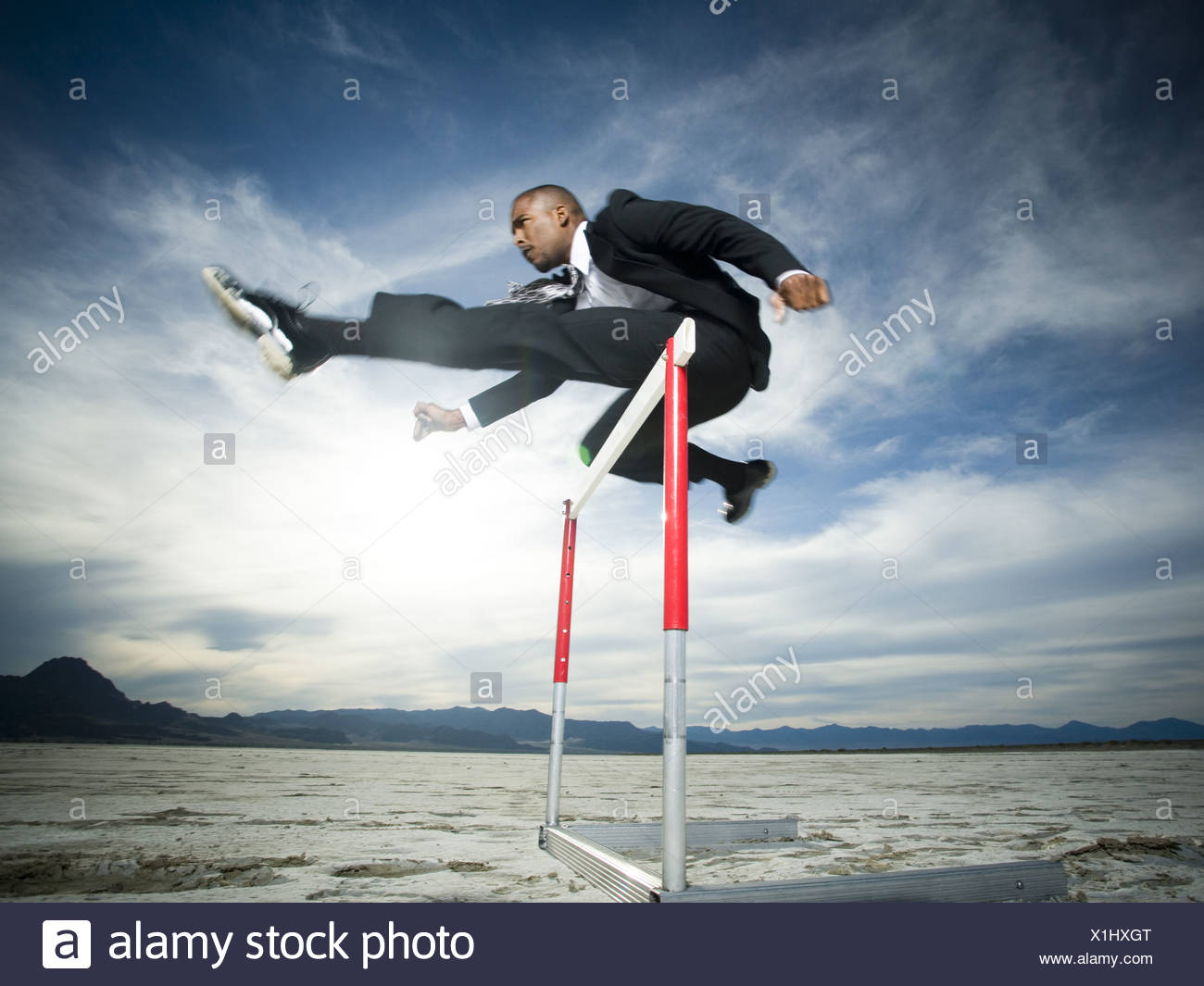 Businessman Jumping Over Hurdle Stock Photos & Businessman Jumping Over ...