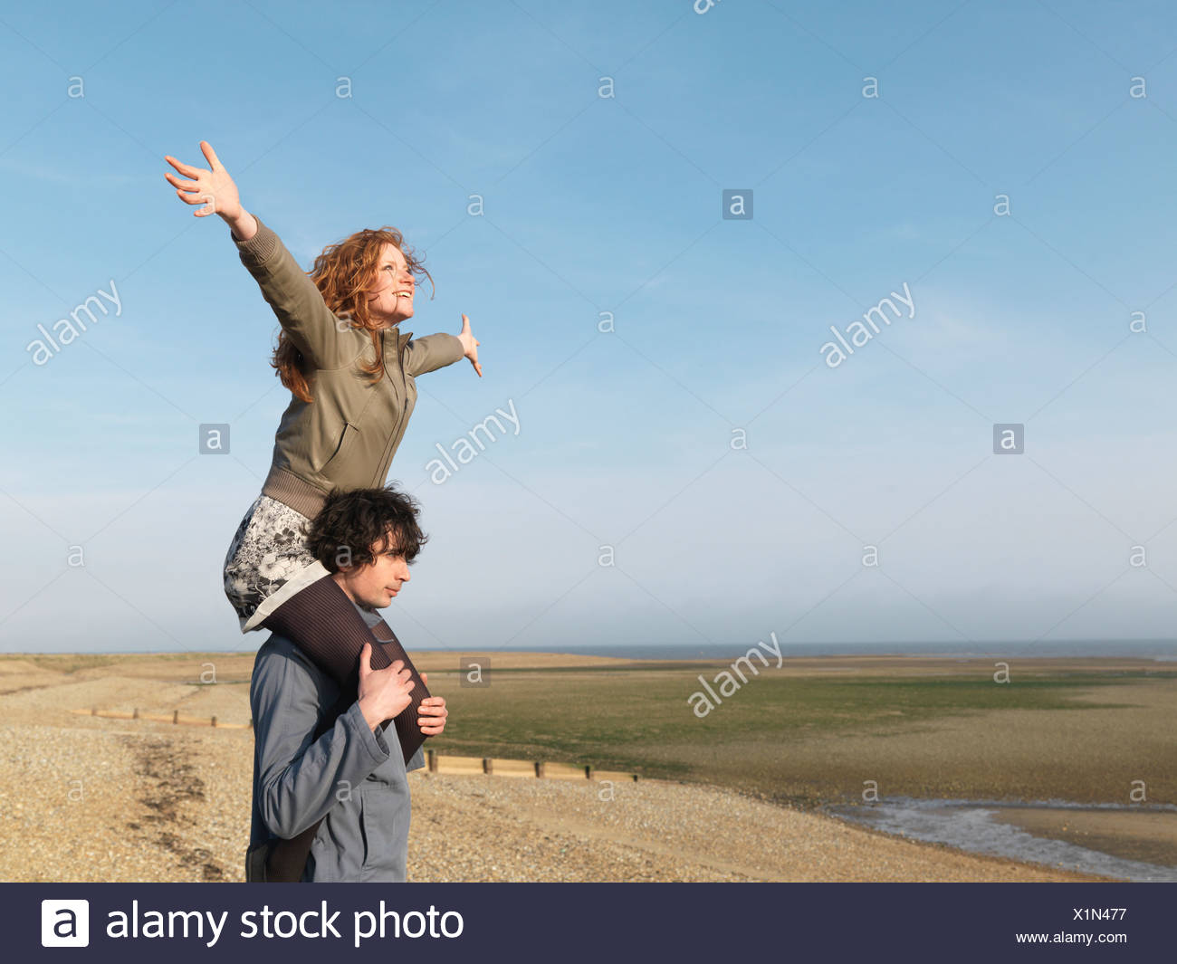 Man Carrying Girlfriend On Shoulders Stock Photos & Man Carrying ...