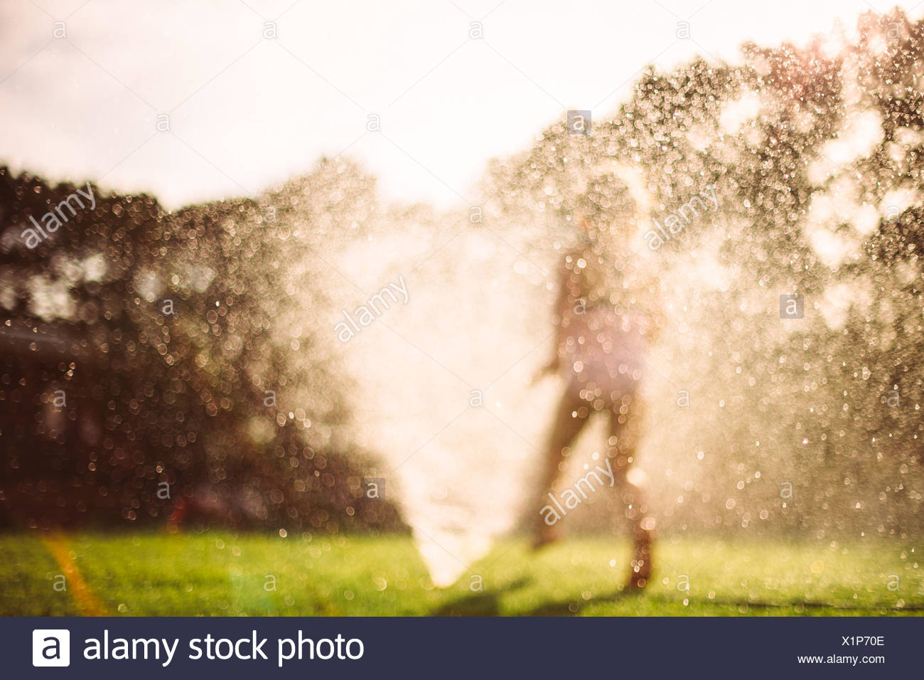Girl Running Through Sprinkler High Resolution Stock Photography and Images - Alamy