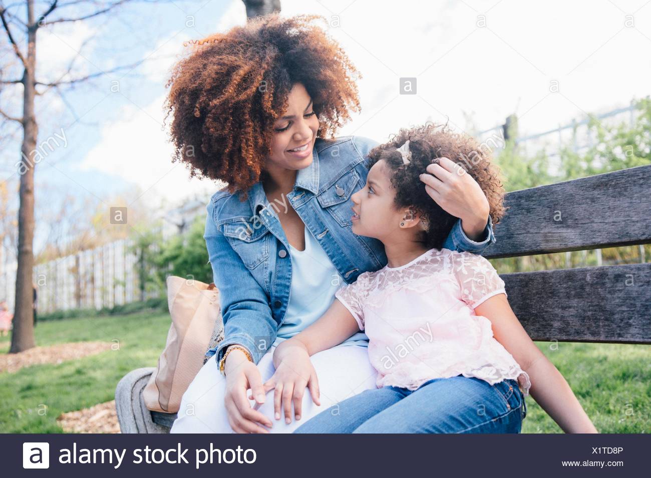 Mother And Daughter Sitting On Bench High Resolution Stock Photography ...