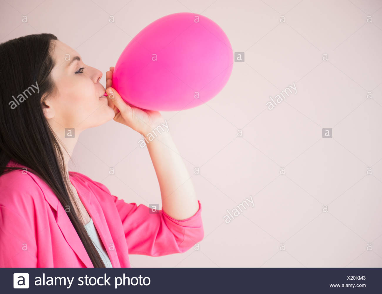 Woman Blowing Balloon High Resolution Stock Photography and Images - Alamy