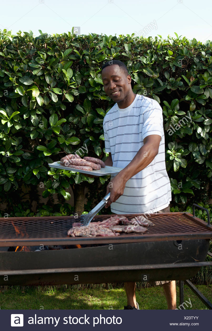 African Man Cooking Meat High Resolution Stock Photography and Images ...