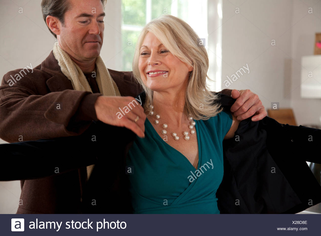 Man Putting On Coat Stock Photos & Man Putting On Coat Stock Images - Alamy
