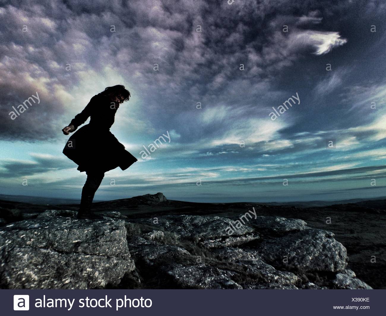 Silhouette Woman Standing On Rock Stock Photos & Silhouette Woman ...