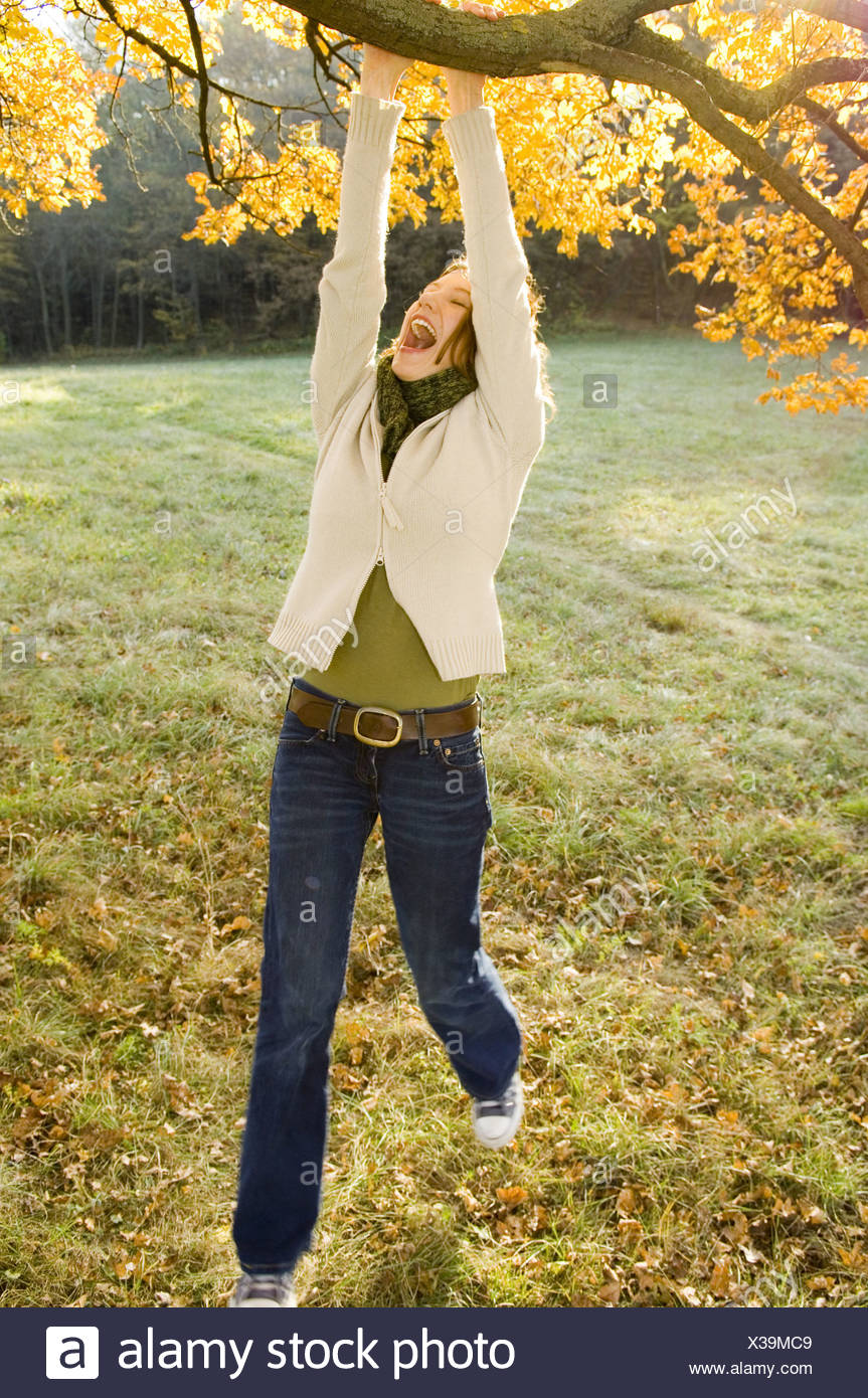 Girl Hanging From Tree Branch High Resolution Stock Photography and ...