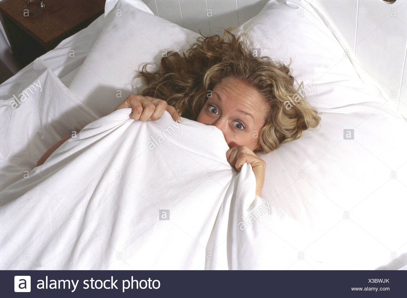 Woman Covered In Sheet Lying In Bed High Resolution Stock Photography ...