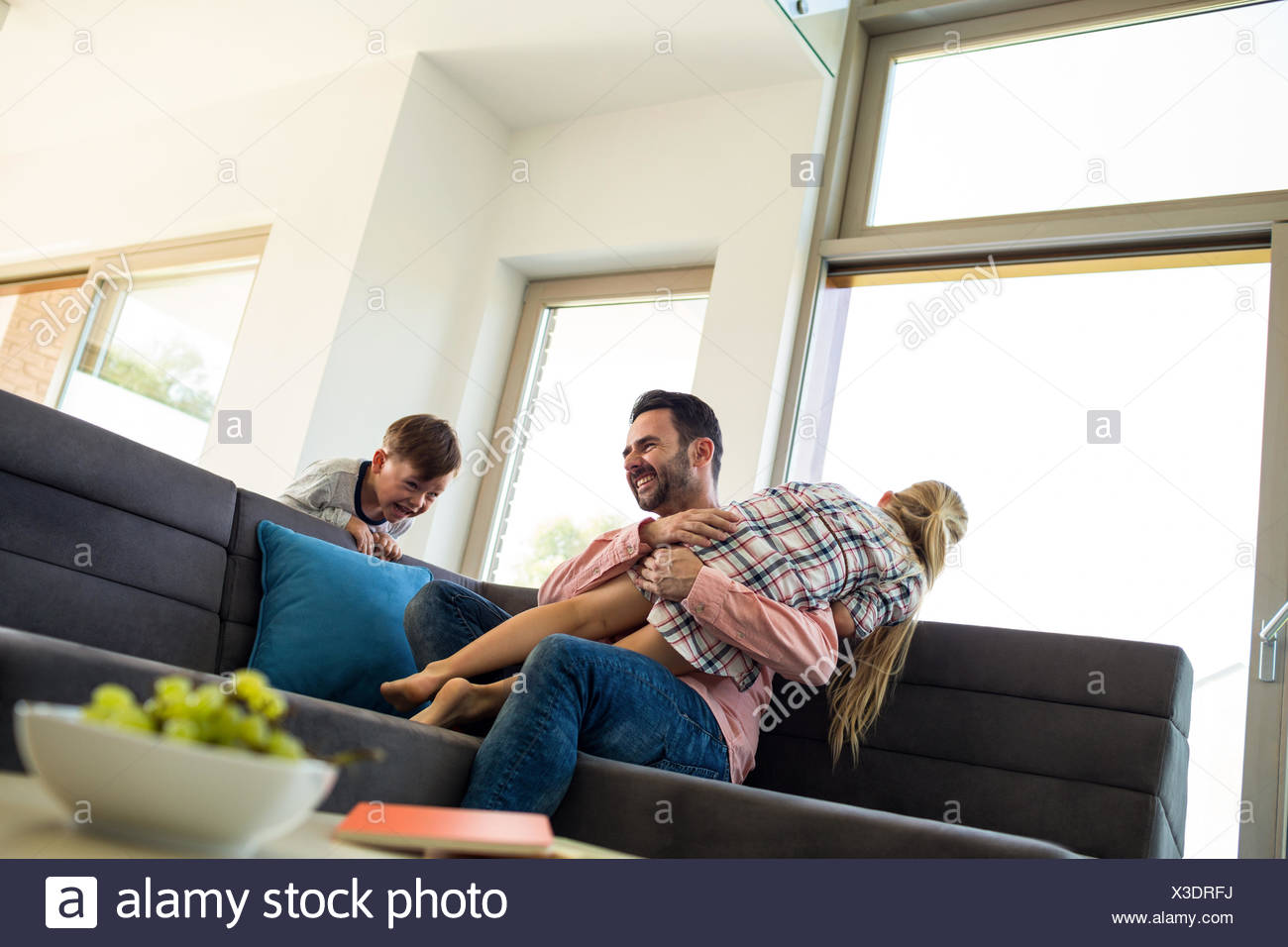 Father Tickling Daughter On The Sofa Stock Photos & Father Tickling ...