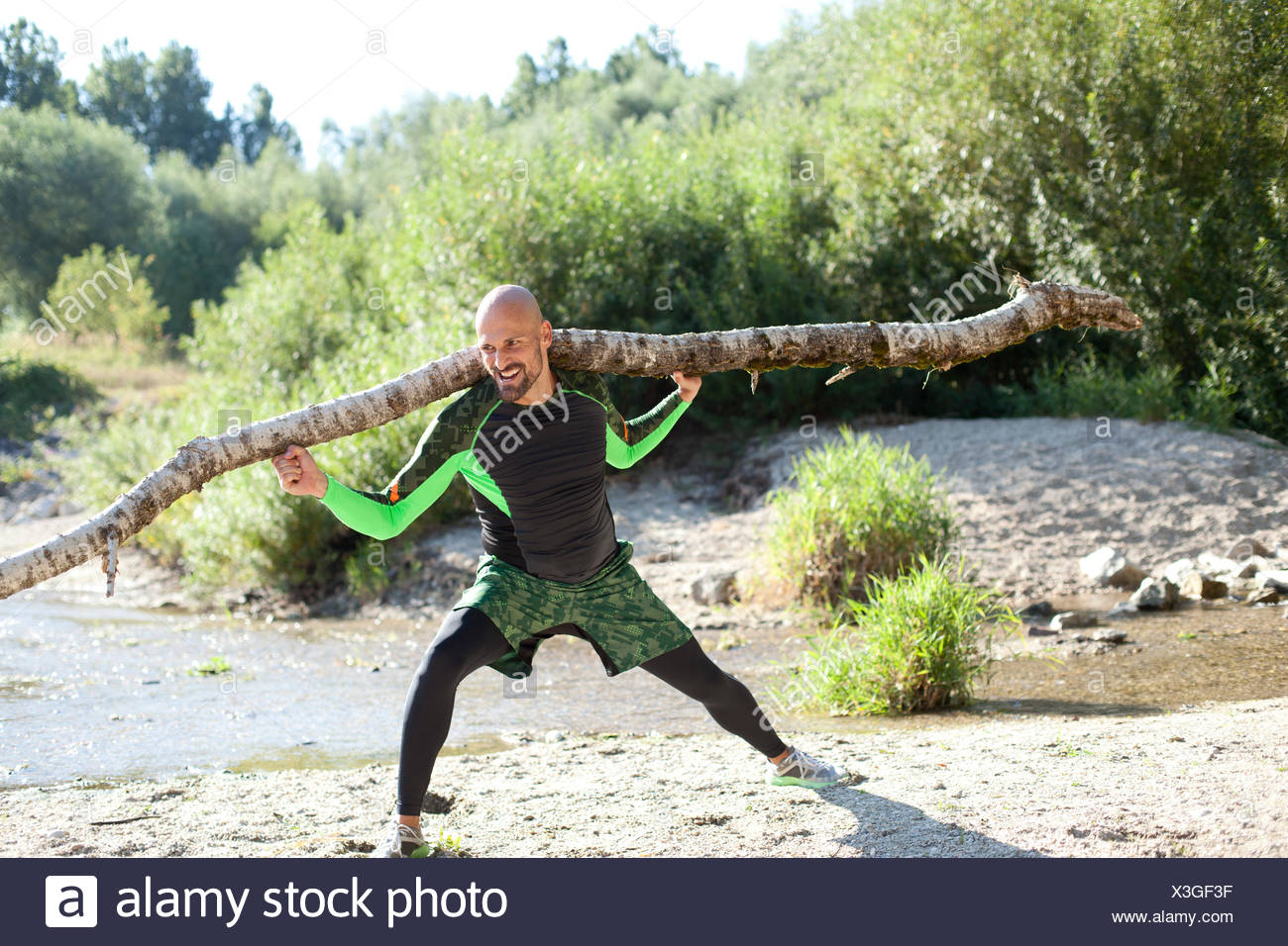 Man Carrying Log On Shoulders High Resolution Stock Photography and ...