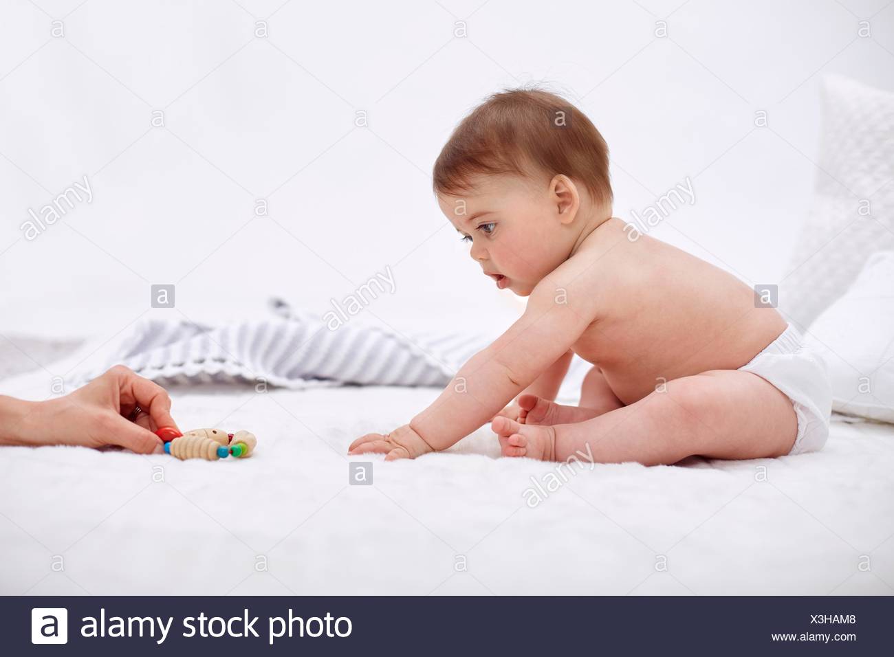 Baby Reaching For Toy High Resolution Stock Photography and Images - Alamy