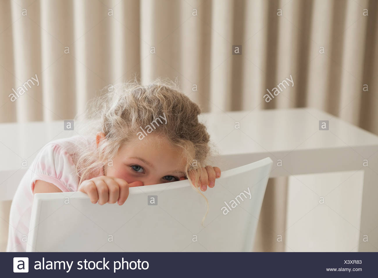 Girl Hiding Behind Chair Stock Photos & Girl Hiding Behind Chair Stock ...