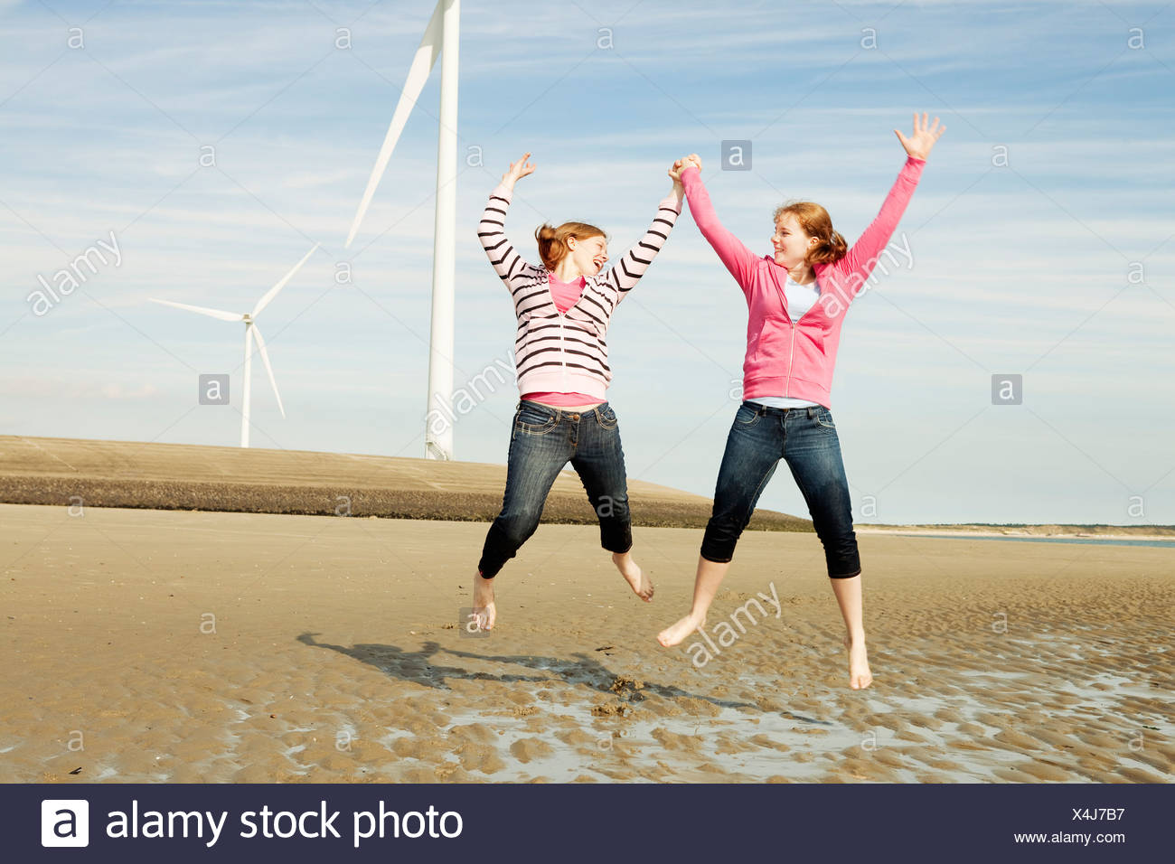 Two Happy Girls Jumping On High Resolution Stock Photography and Images ...