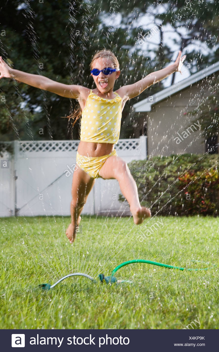 Girl Running Through Sprinkler High Resolution Stock Photography and ...