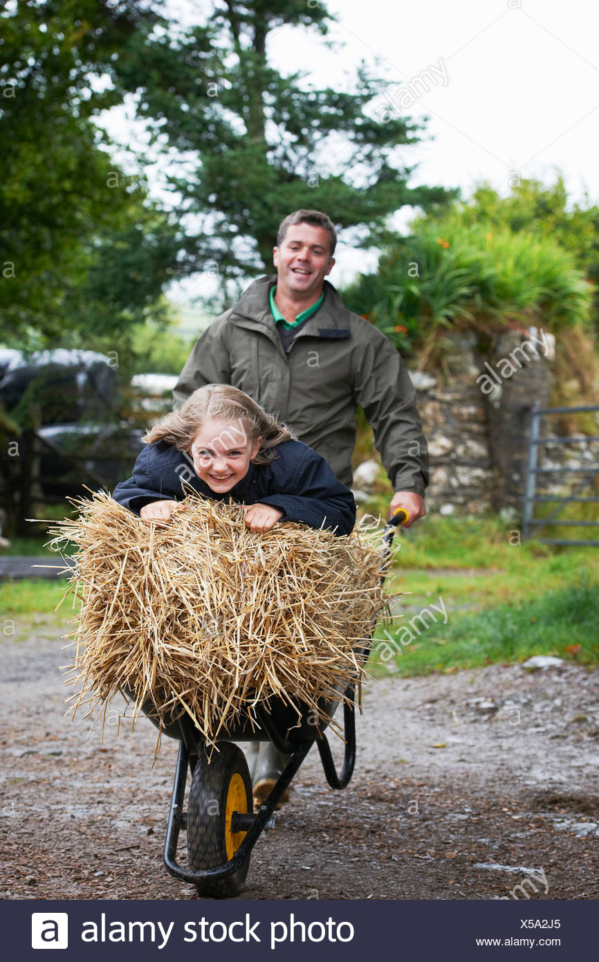 Man Pushing Wheel Barrow Stock Photos & Man Pushing Wheel Barrow Stock ...