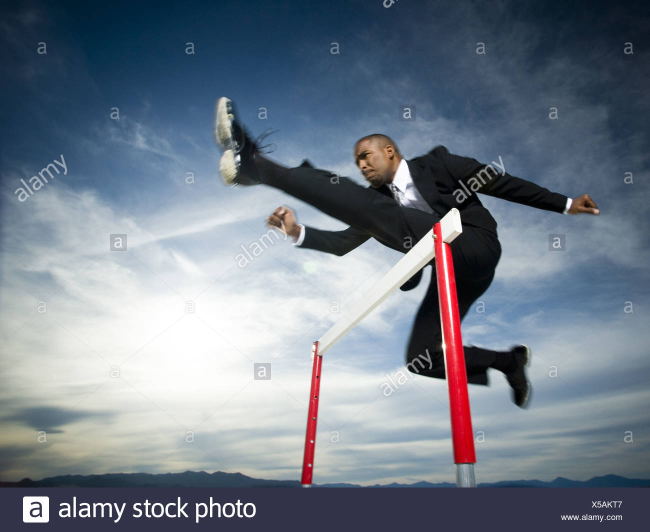 Businessman Jumping Over Hurdle Stock Photos & Businessman Jumping Over ...