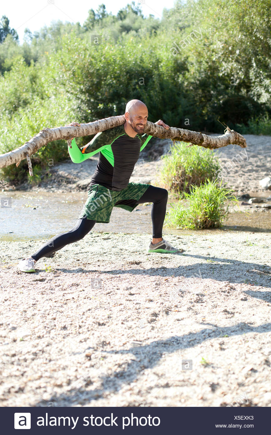 Man Carrying Log On Shoulders High Resolution Stock Photography and ...