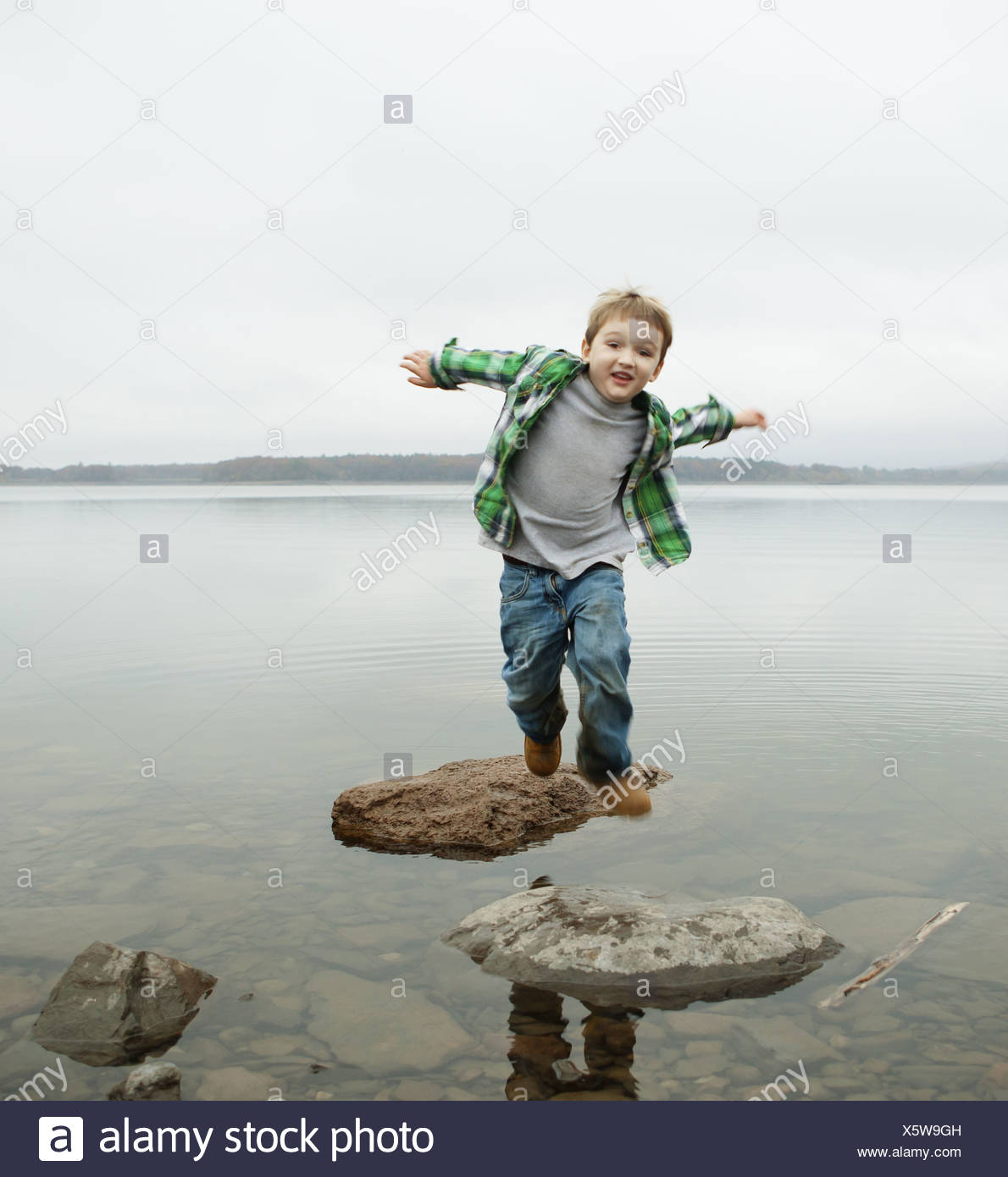 Boy Jumping Across Water High Resolution Stock Photography and Images ...