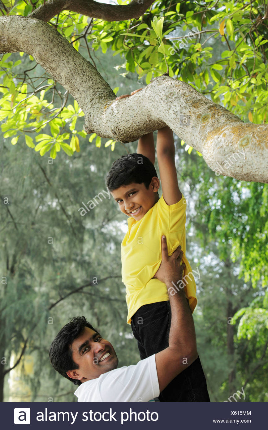 Boy Hanging From Branch Tree Stock Photos & Boy Hanging From Branch ...