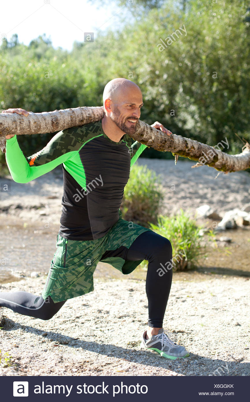 Man Carrying Log On Shoulders High Resolution Stock Photography and ...