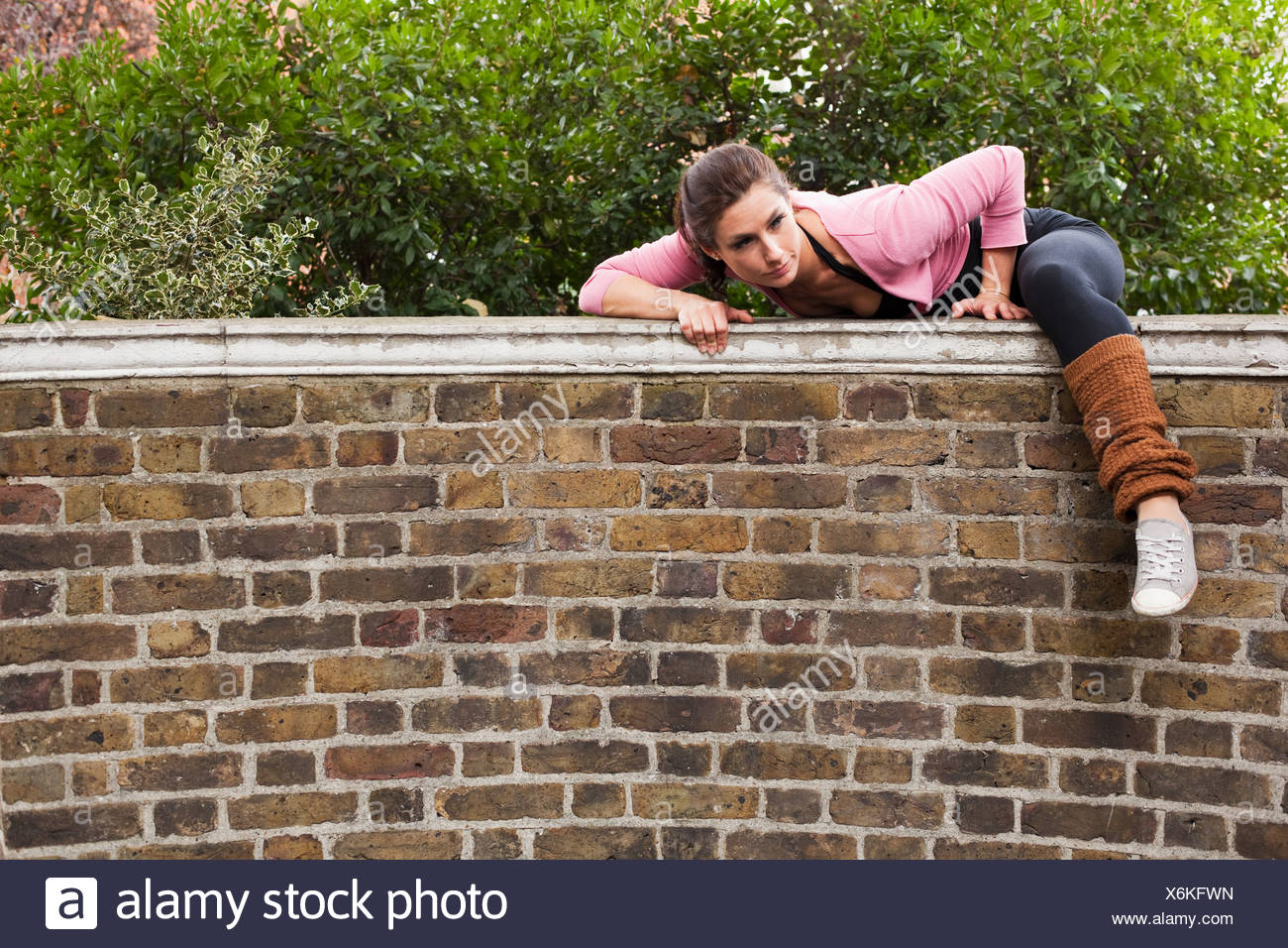 Woman Climbing Over Wall High Resolution Stock Photography and Images ...
