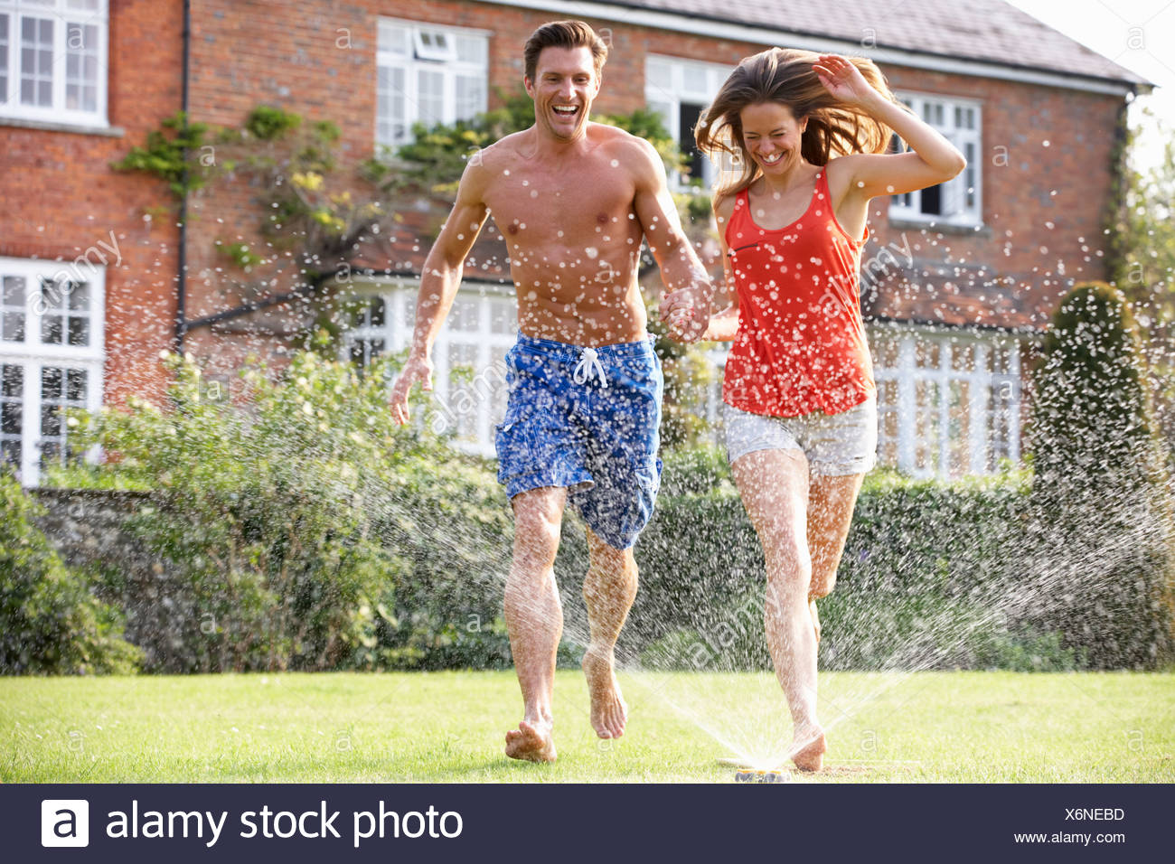 Running Through The Sprinkler High Resolution Stock Photography and ...