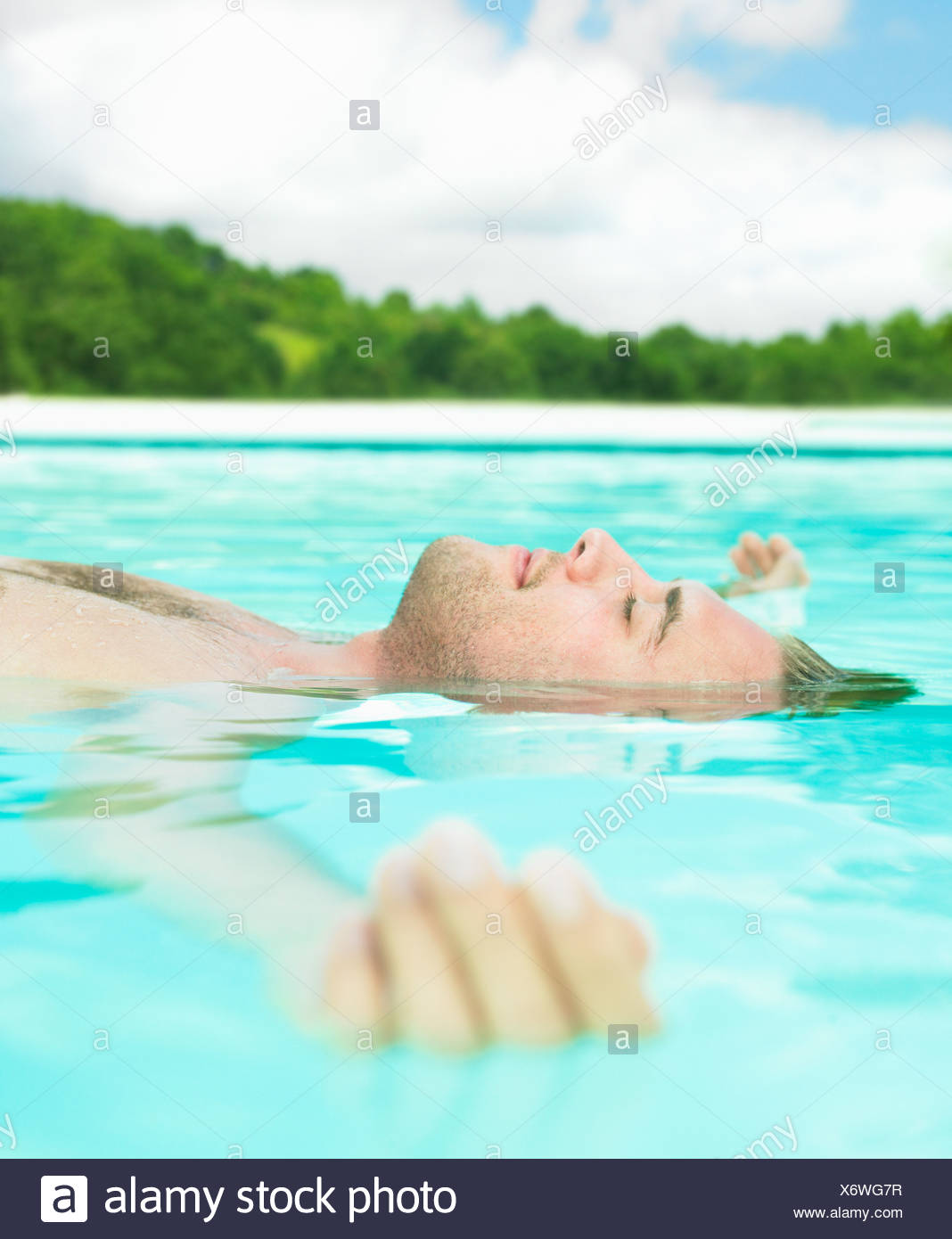Man Floating In Swimming Pool High Resolution Stock Photography and ...