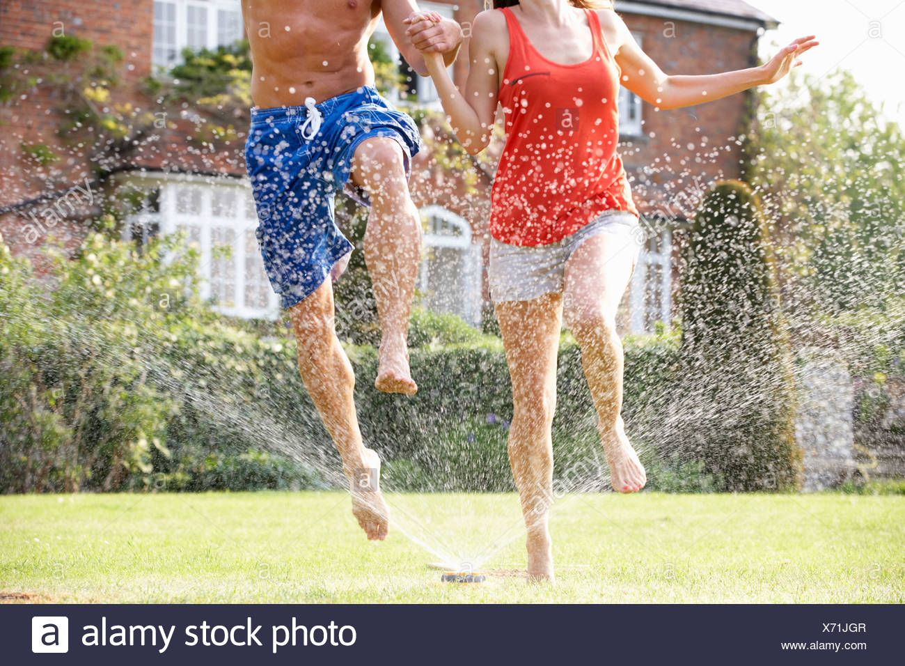 Running Through The Sprinkler High Resolution Stock Photography and ...