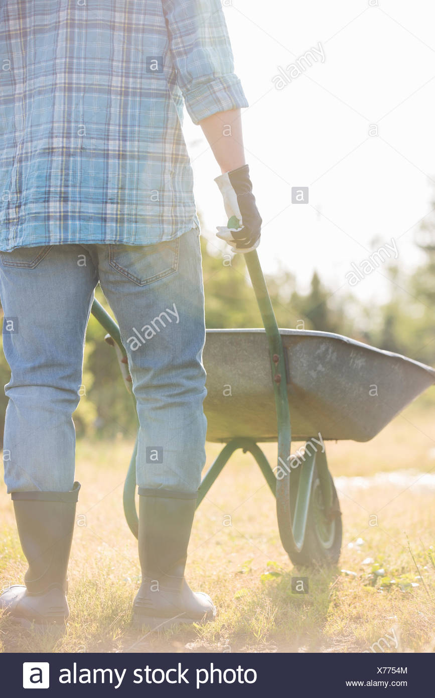 Man With Wheelbarrow Stock Photos & Man With Wheelbarrow Stock Images ...