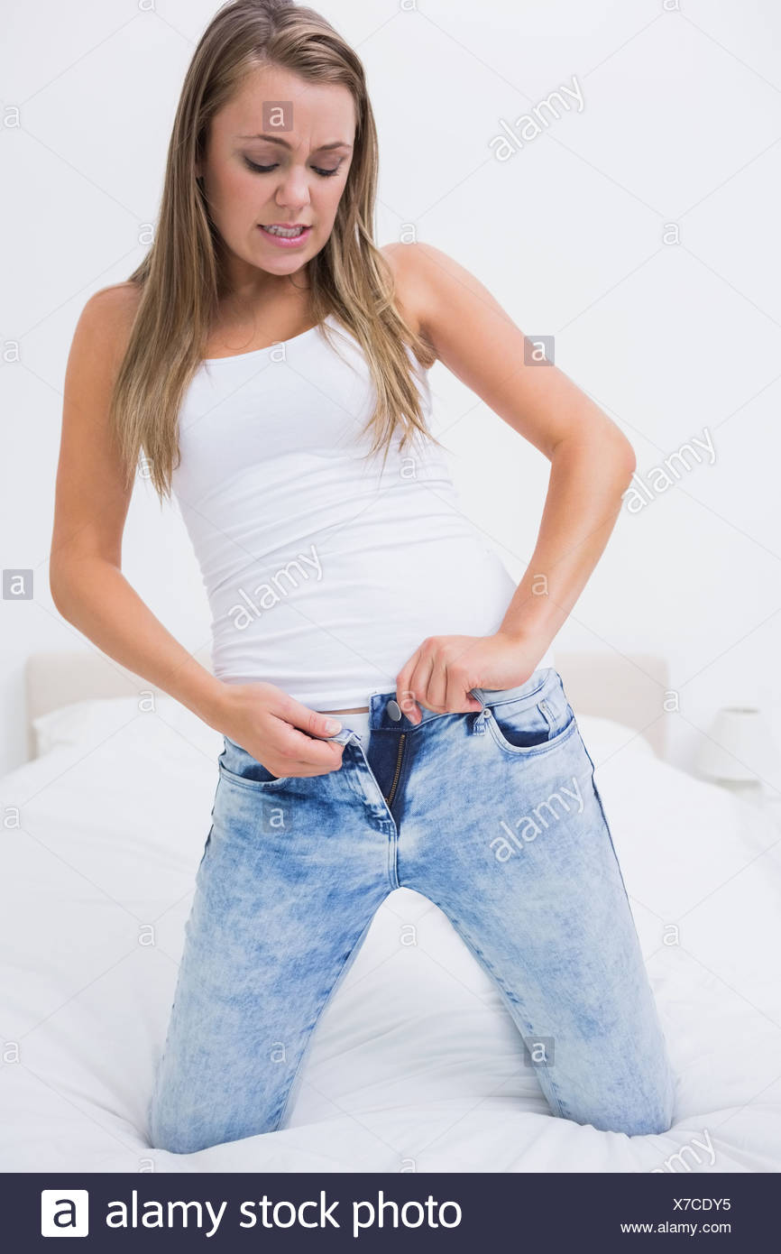 Woman Putting On Tight Jeans High Resolution Stock Photography and ...