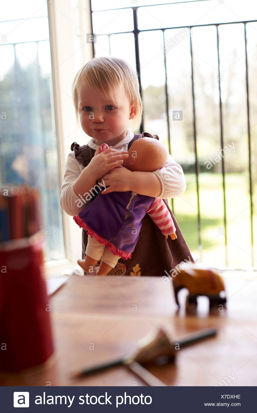 Girl Holding Baby Doll High Resolution Stock Photography and Images - Alamy