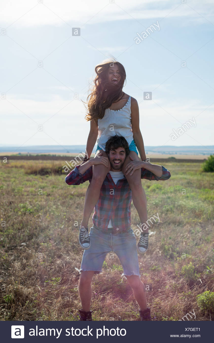 Man Shoulder Carrying Woman Stock Photos & Man Shoulder Carrying Woman ...
