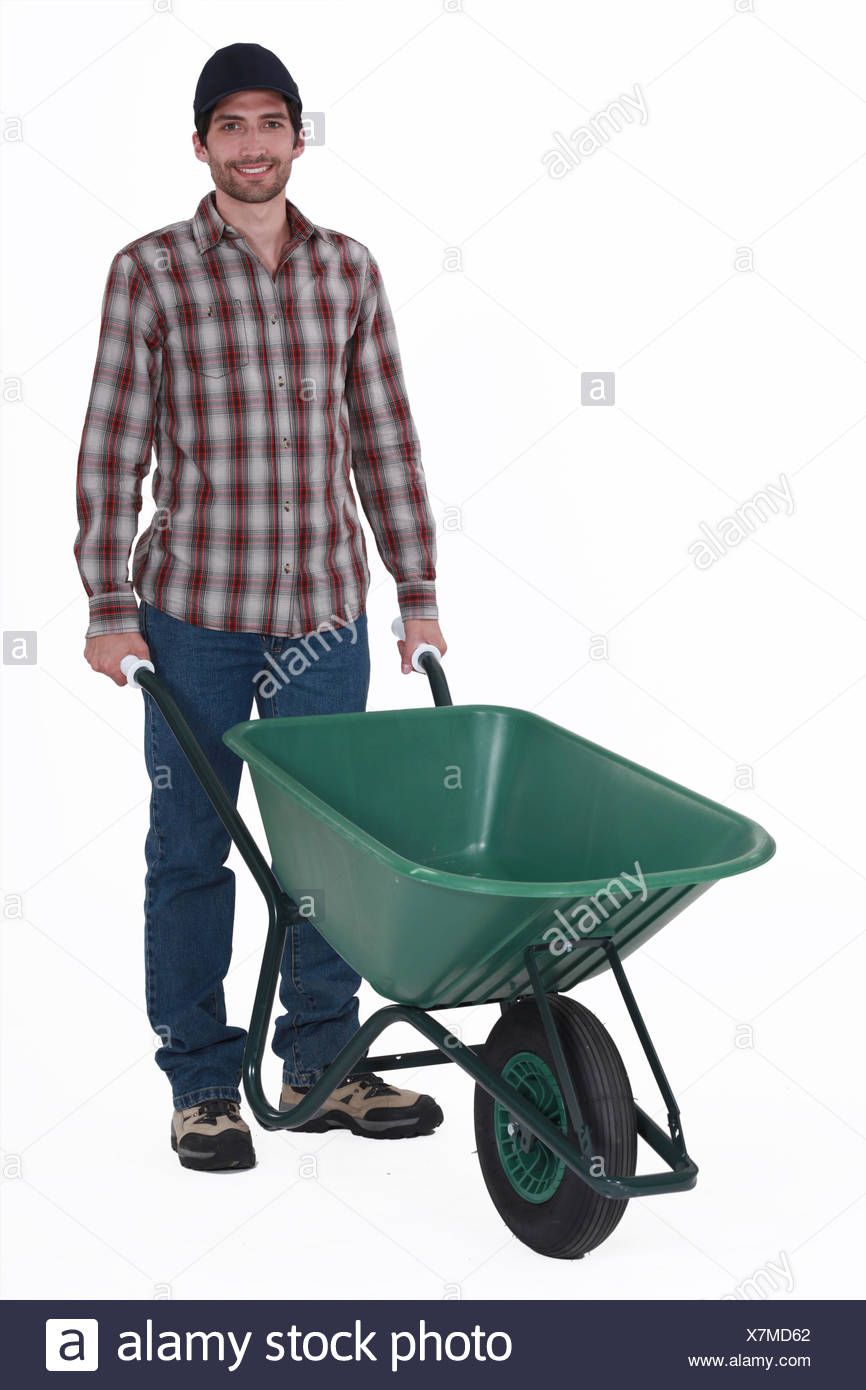 Man Hauling Barrow Stock Photos & Man Hauling Barrow Stock Images - Alamy