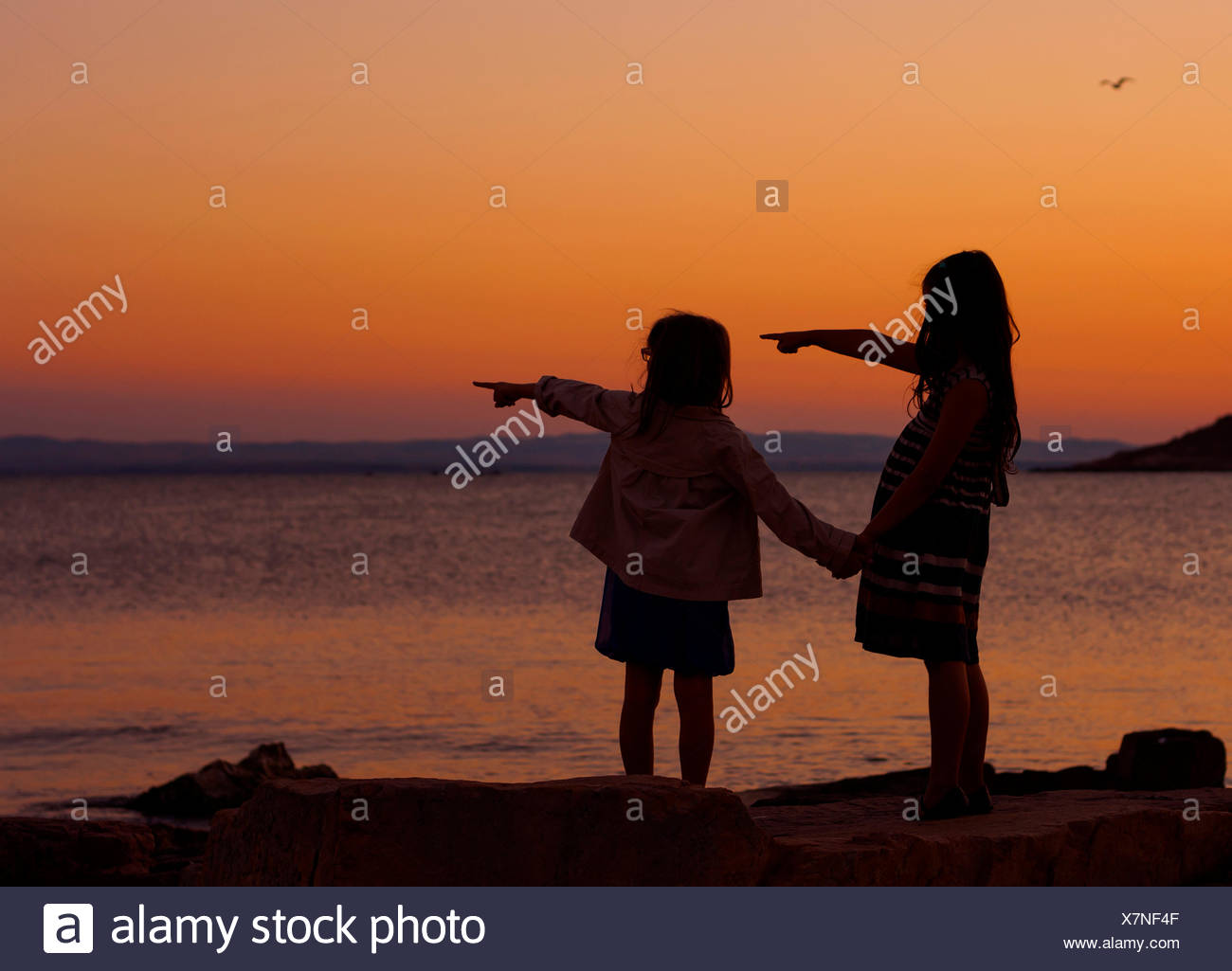 Silhouette Of Two Girls At Sunset Stock Photos & Silhouette Of Two ...