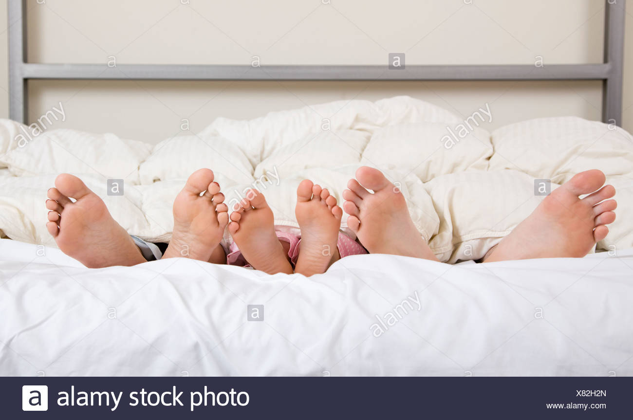 Family Of Three People Sleeping In One Bed Stock Photos & Family Of ...
